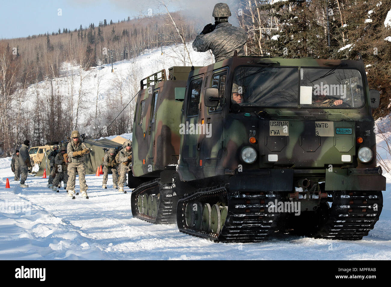 Soldiers skijour behind a Small Unit Support Vehicle as part of U.S ...