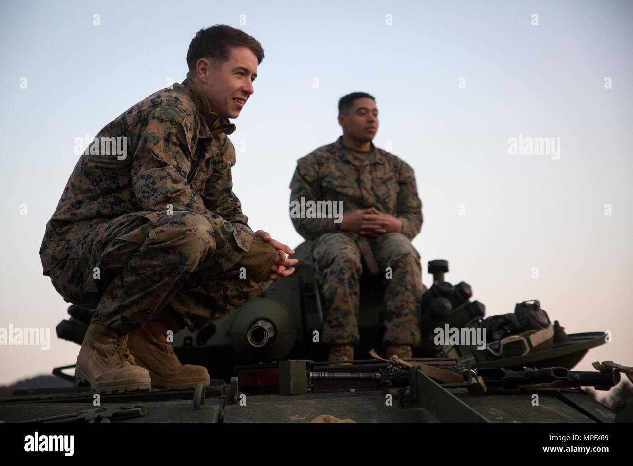 U.S. Marine Corps Cpl. Brandon Ratliff talks with other Marines at an ...