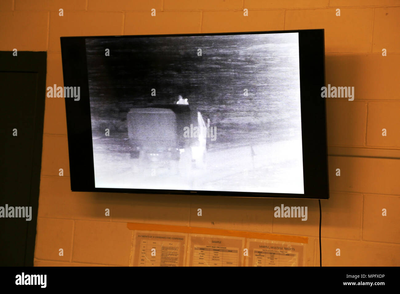 A television screen from a range camera captures Soldiers participating ...