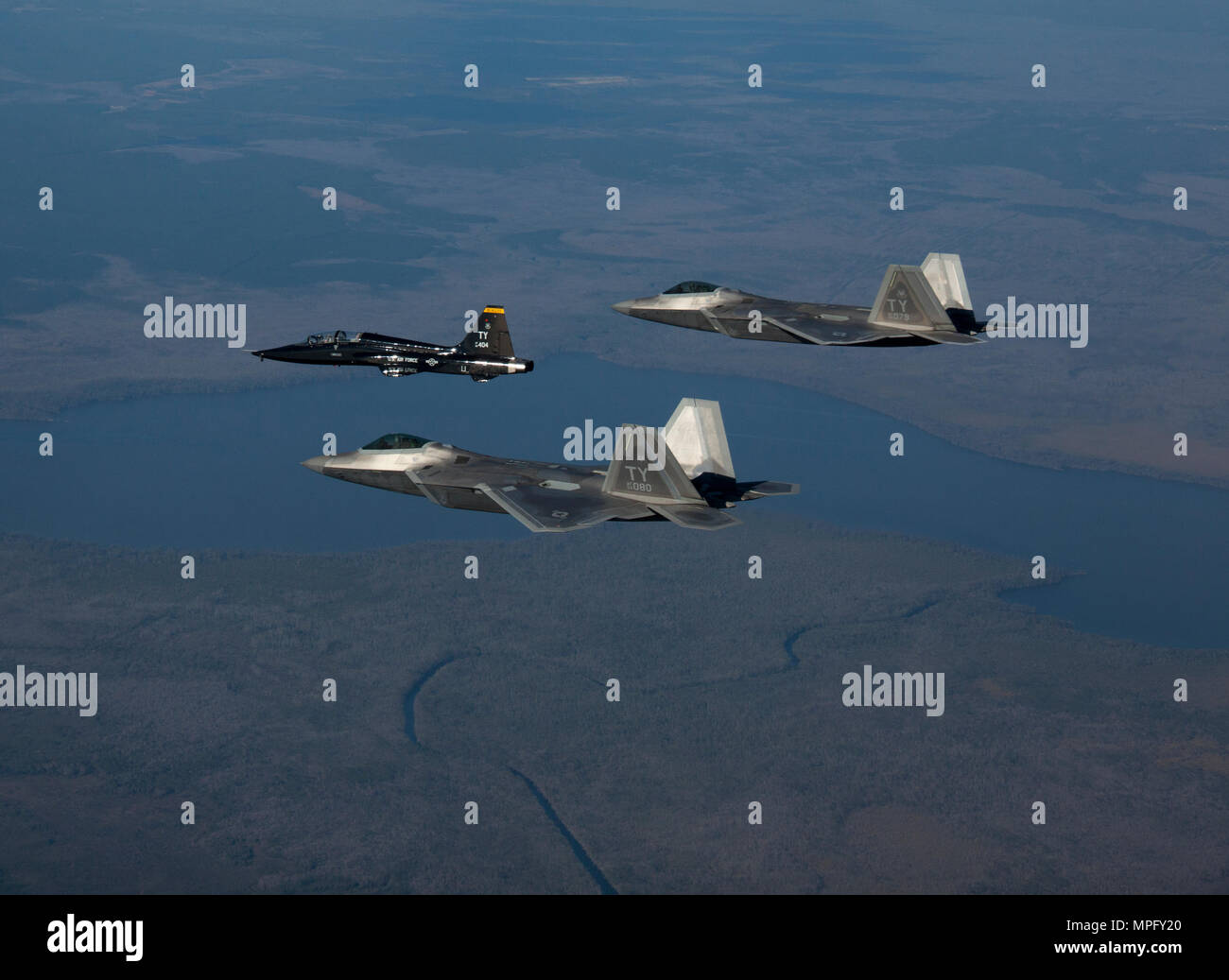 A pair of F-22 Raptors with the 95th Fighter Squadron and a T-38 Talon ...
