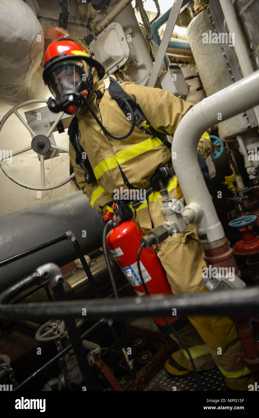 ATLANTIC OCEAN (March 10, 2017) – Fireman Jake Denault investigates the ...