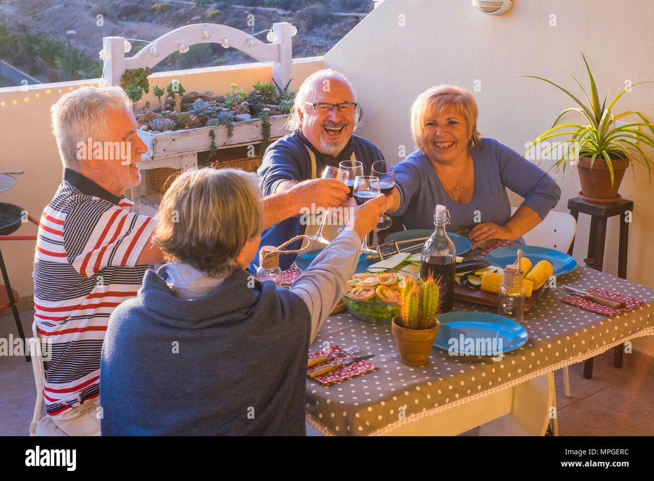 adult group of people having nice dinner outdoor in the terrace. enjoy ...