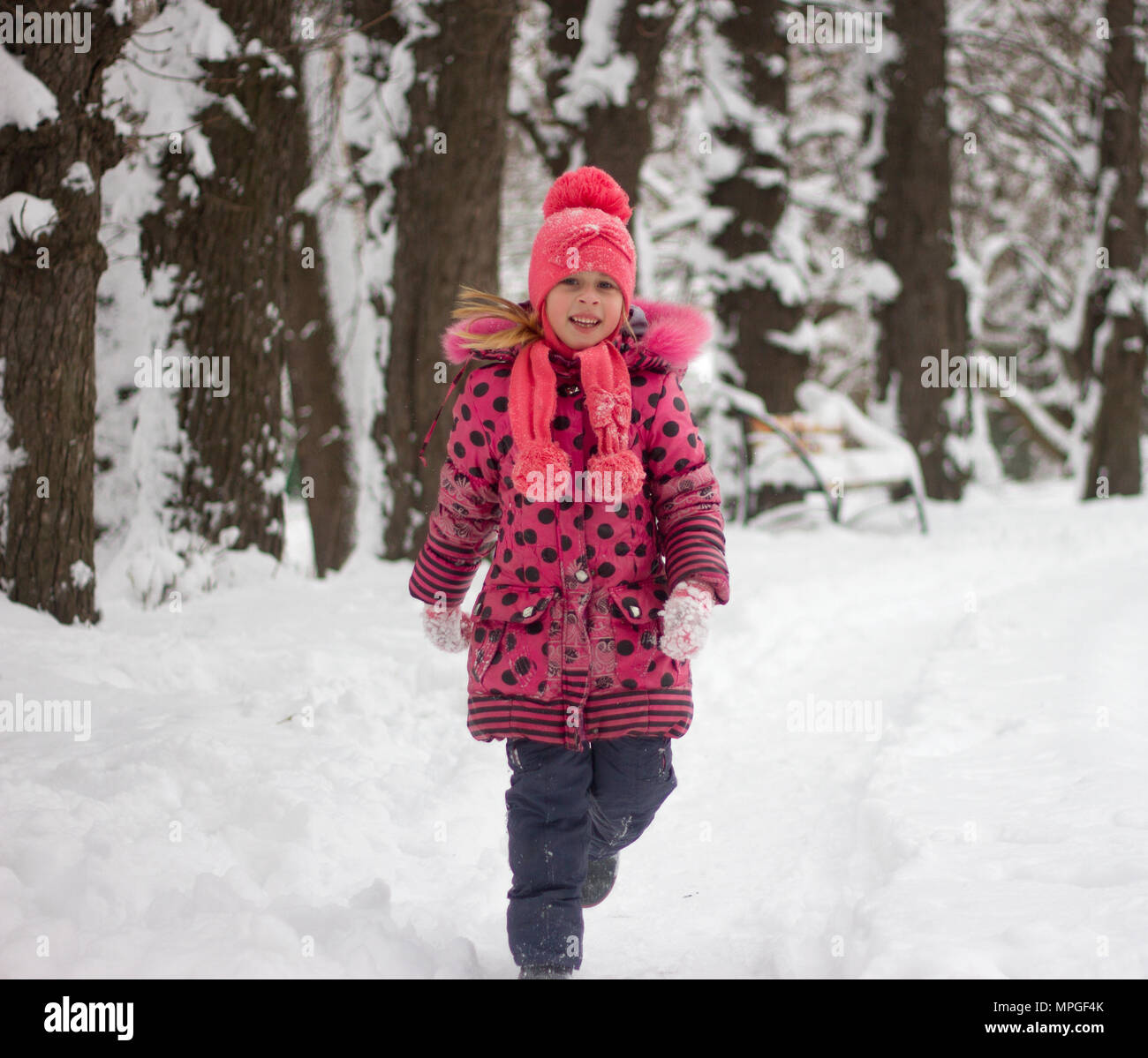 Little girl in winter pink hat in snow Stock Photo - Alamy