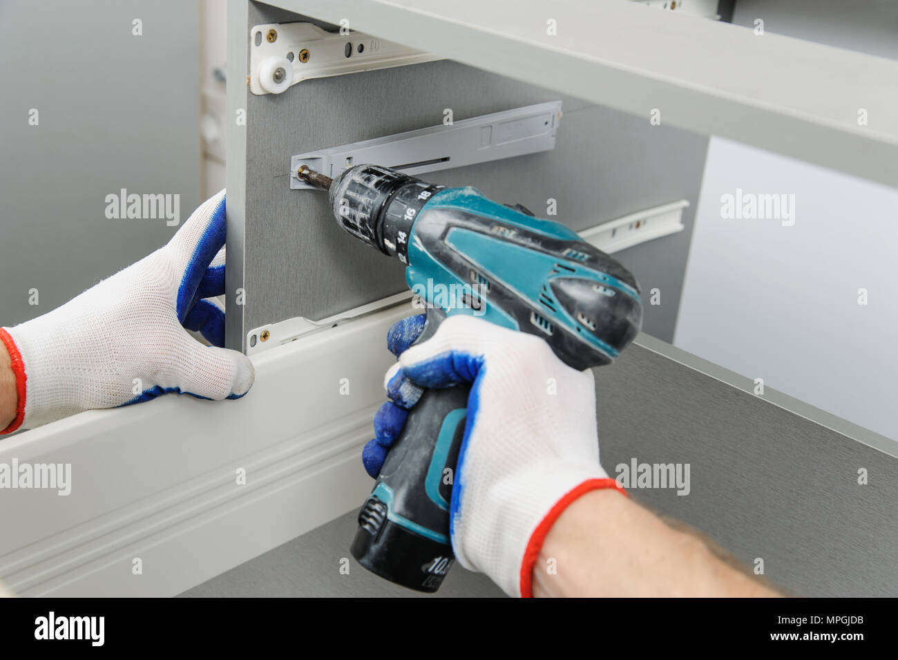 Installation kitchen workman fixes drawer hi-res stock photography and ...