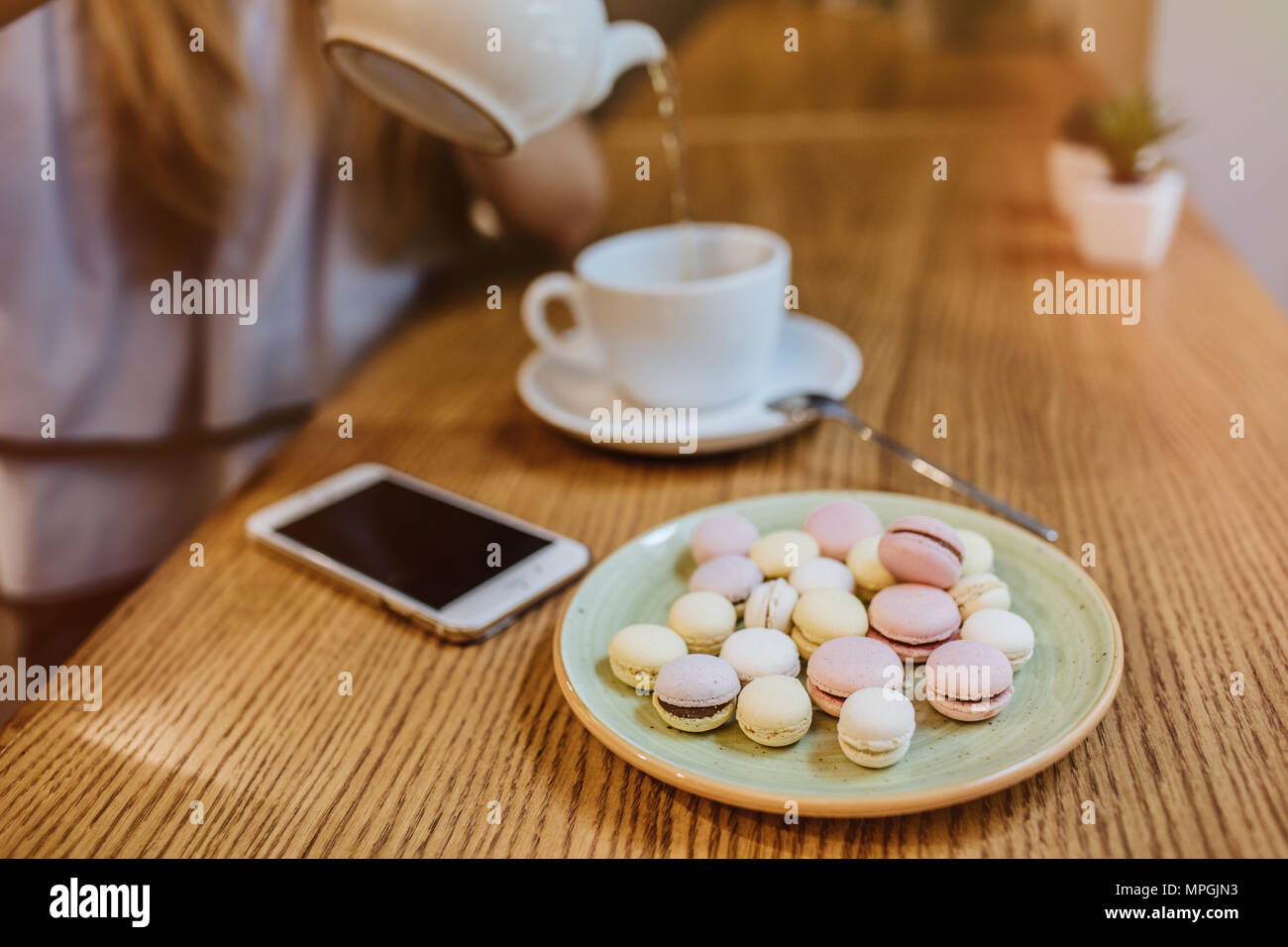 Beautiful young women drinking tea in restaurant Stock Photo - Alamy