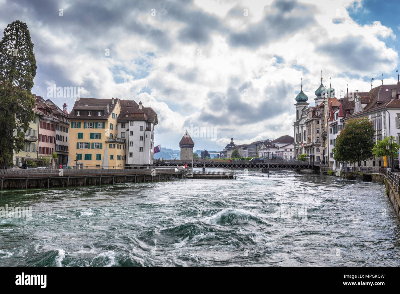 An old European city of Lucerne. Dam with waterfalls on a mountain lake ...