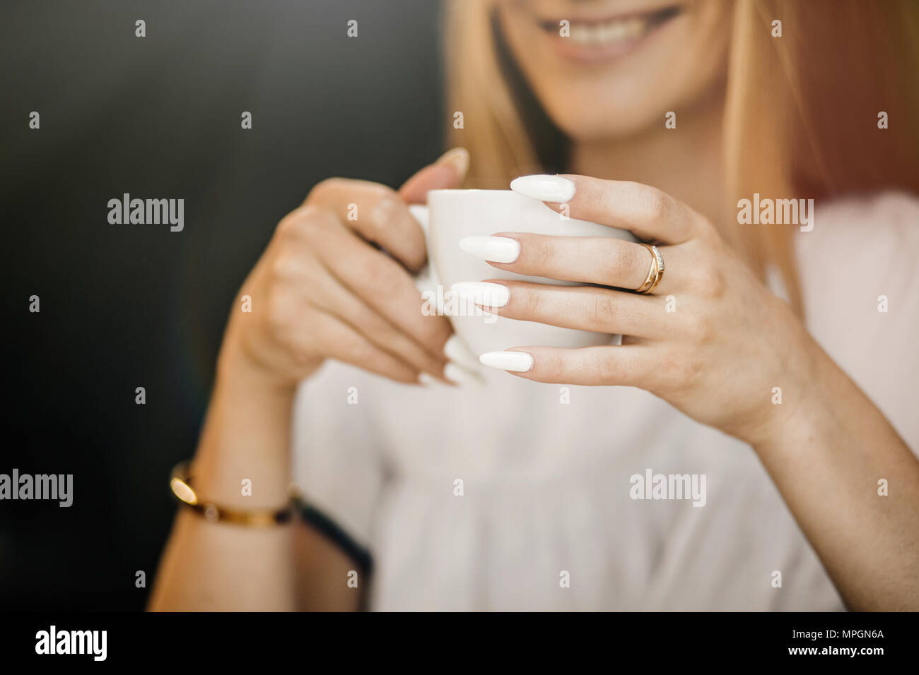 Beautiful young women drinking tea in restaurant Stock Photo - Alamy