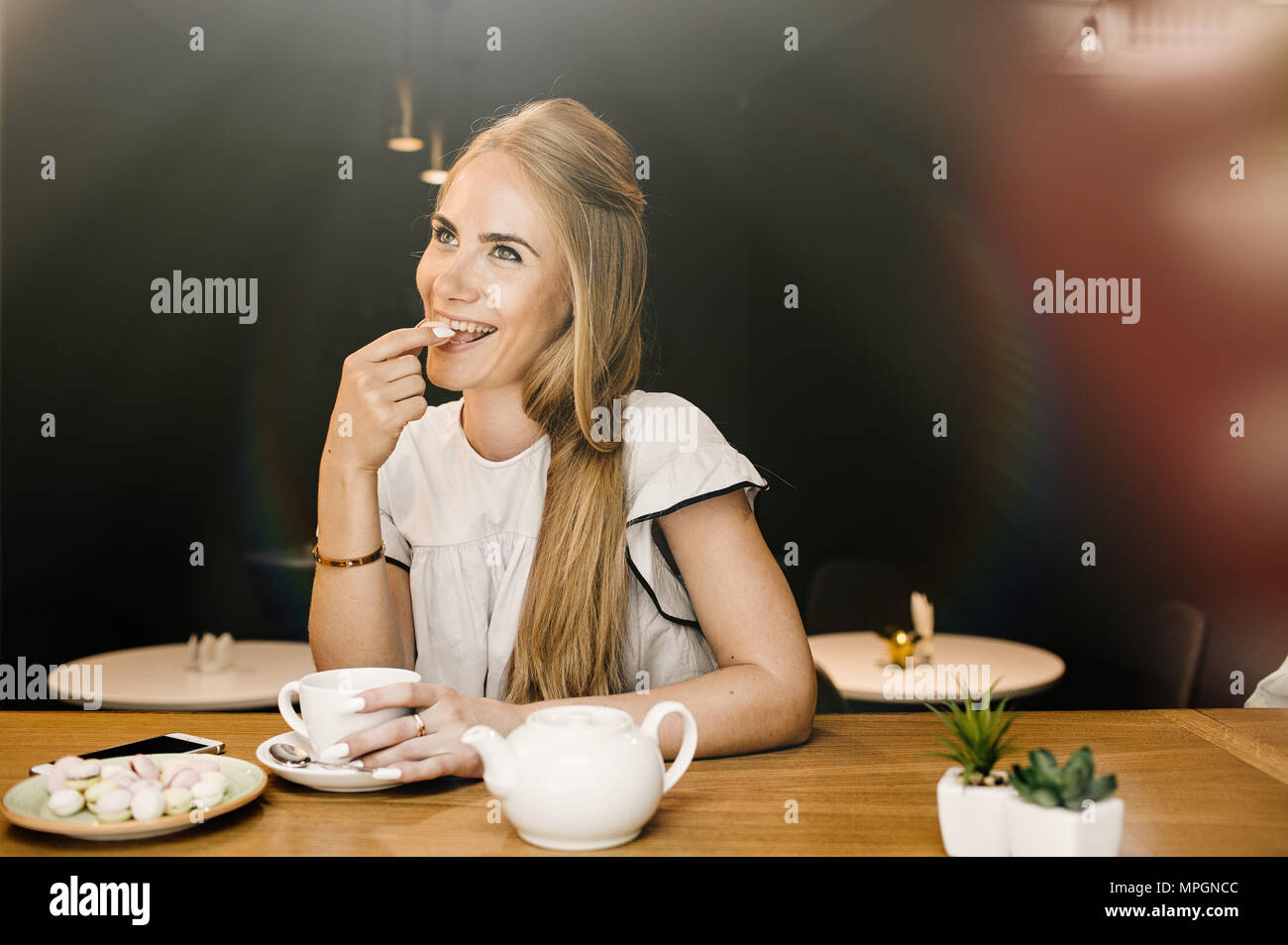 Beautiful young women drinking tea in restaurant Stock Photo - Alamy