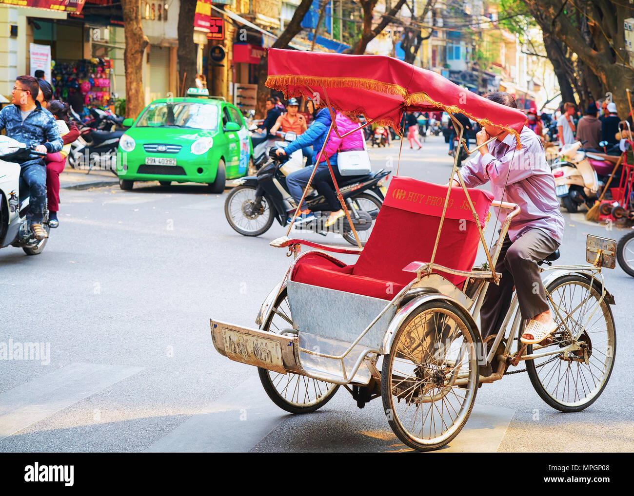 Hanoi, Vietnam - February 21, 2016: Cycle rickshaw on busy street in ...