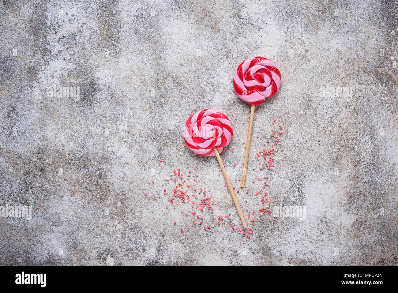 Pink lollipop on light background Stock Photo - Alamy