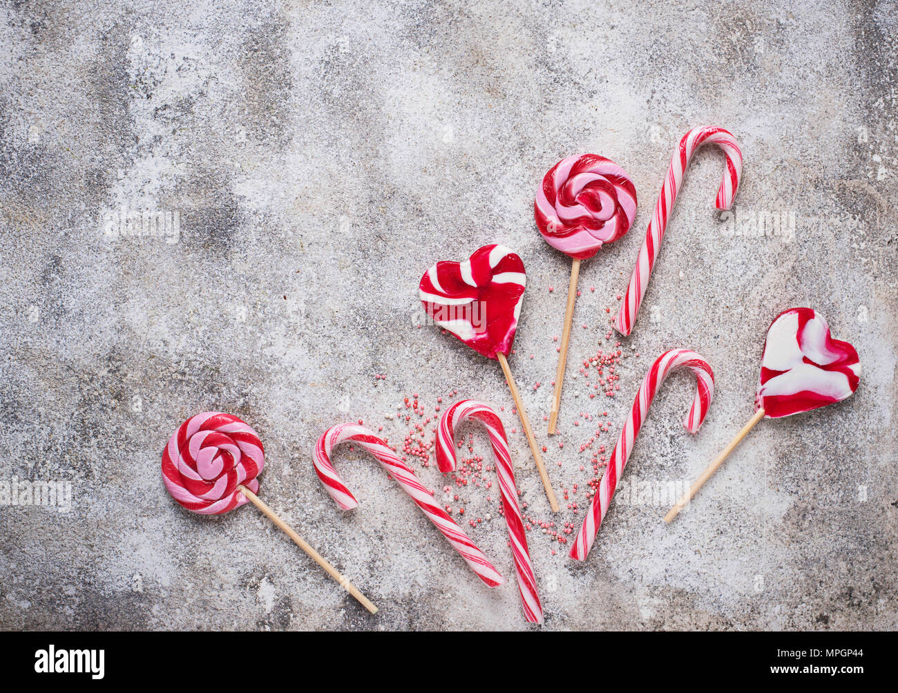 Pink lollipop and candy cane Stock Photo - Alamy
