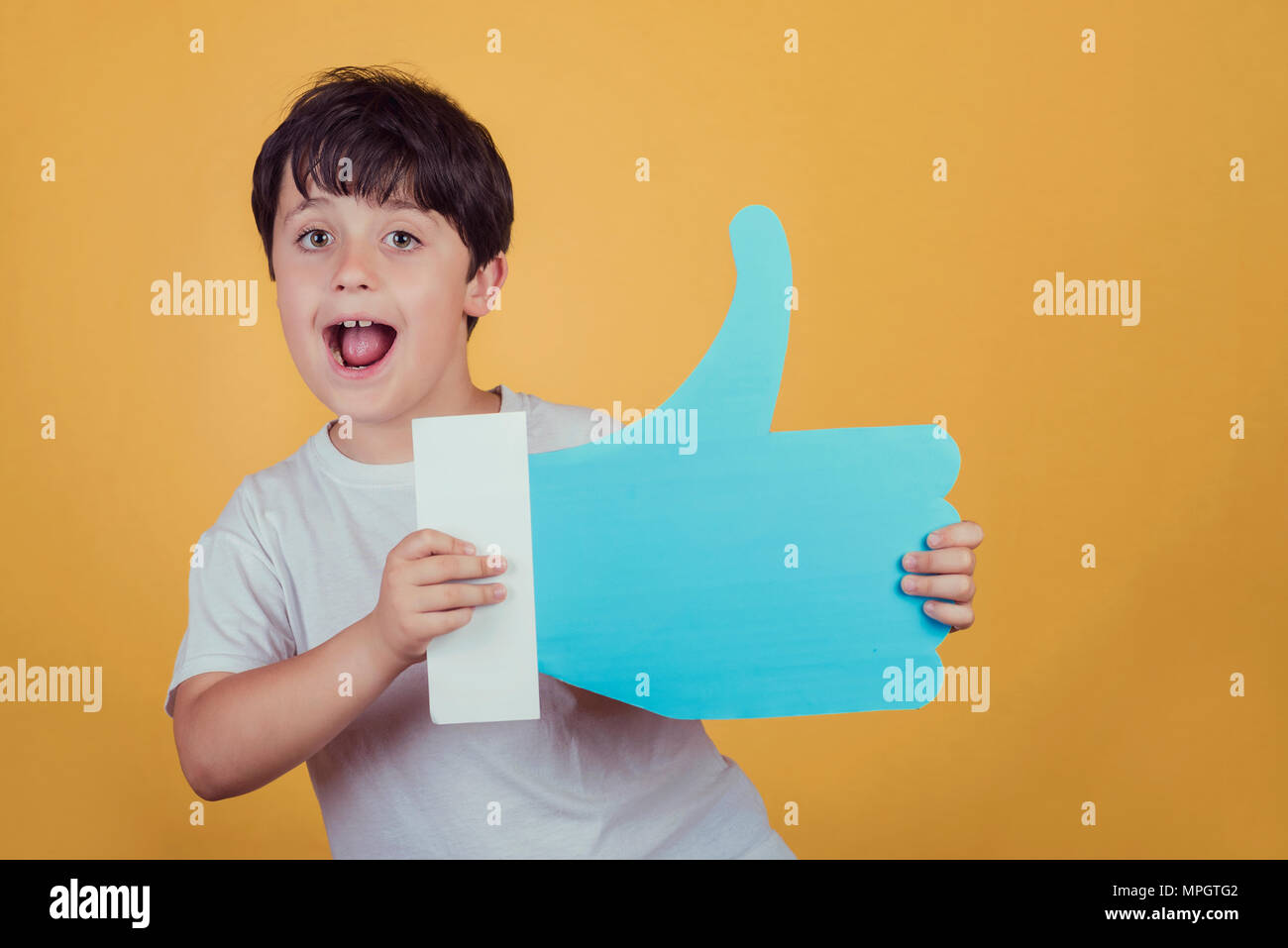 boy with a big like on yellow background Stock Photo - Alamy
