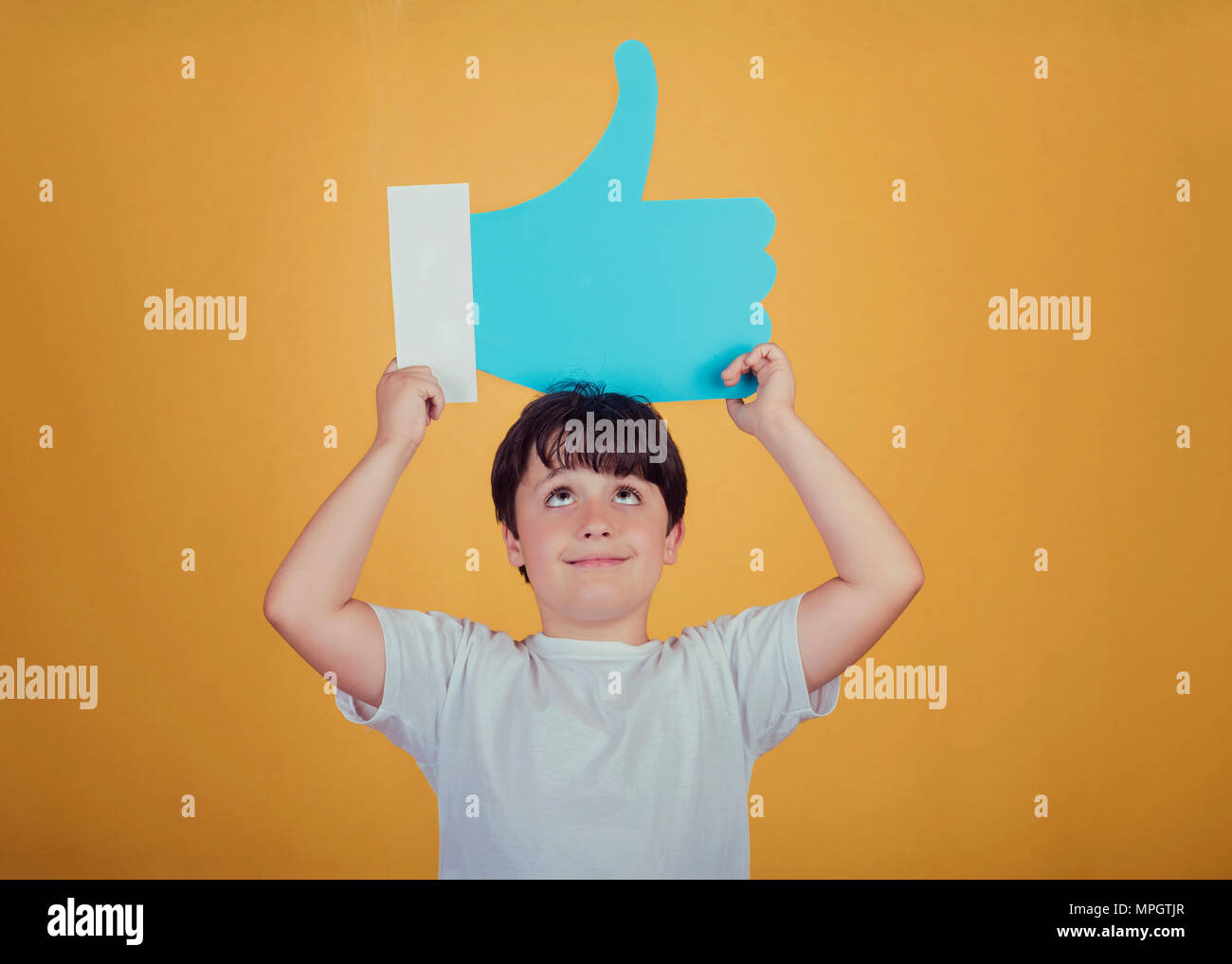 boy with a big like on yellow background Stock Photo - Alamy