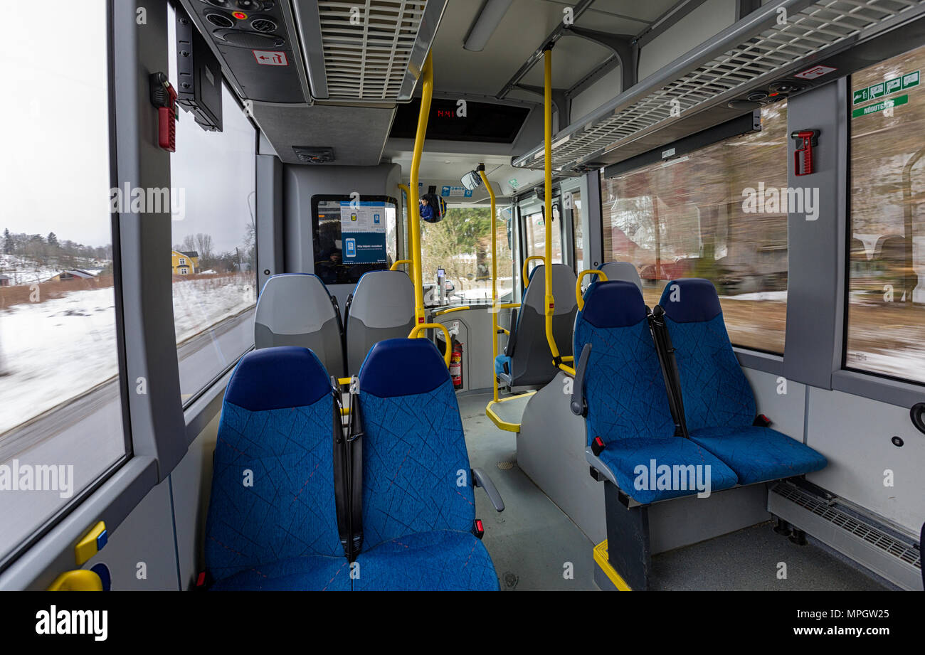 Interior of empty modern swedish bus with bus driver reflected in rear ...