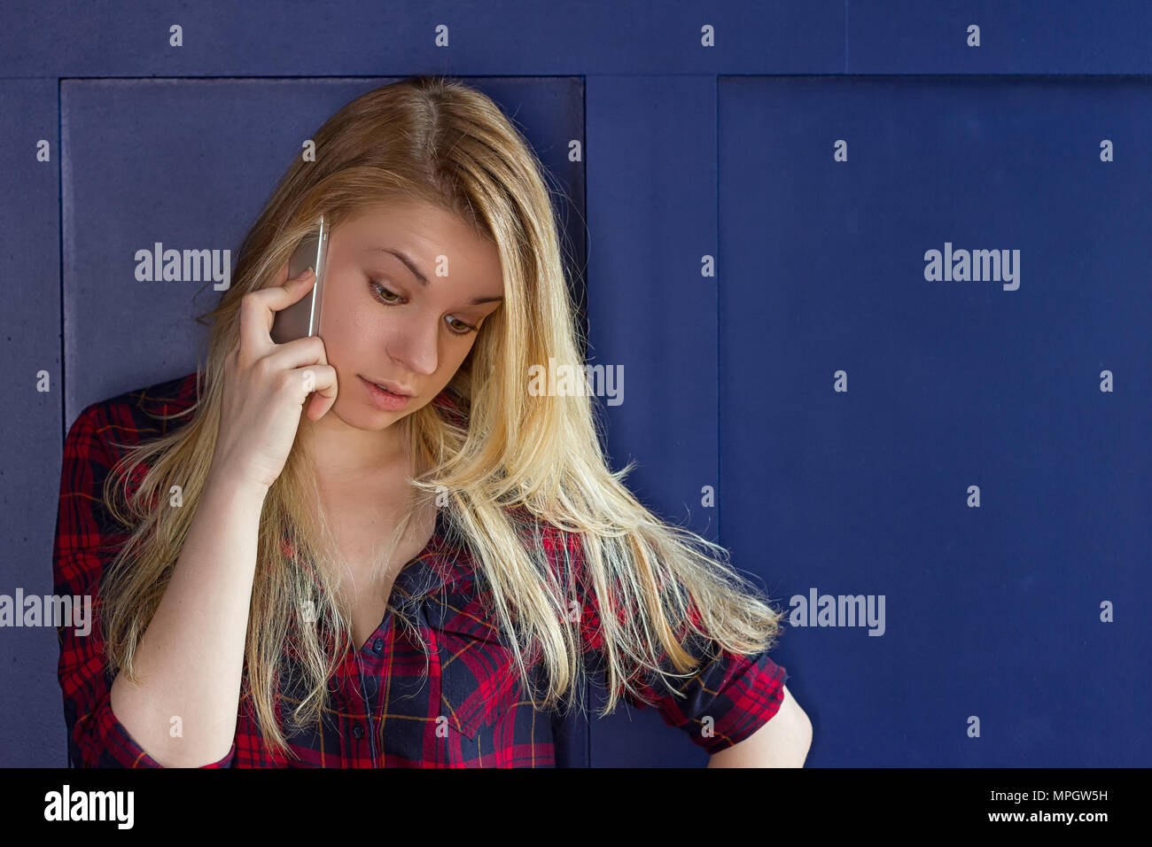 Pretty Woman Calling Someone Through Mobile Phone While Smiling at the ...