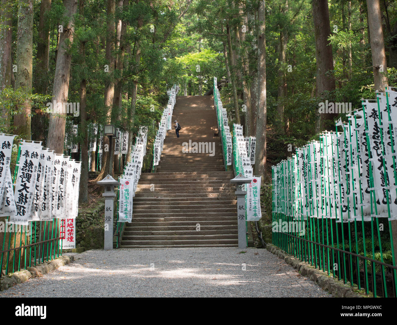 Visitors climb steep stone stairs leading to world heritage shrine ...