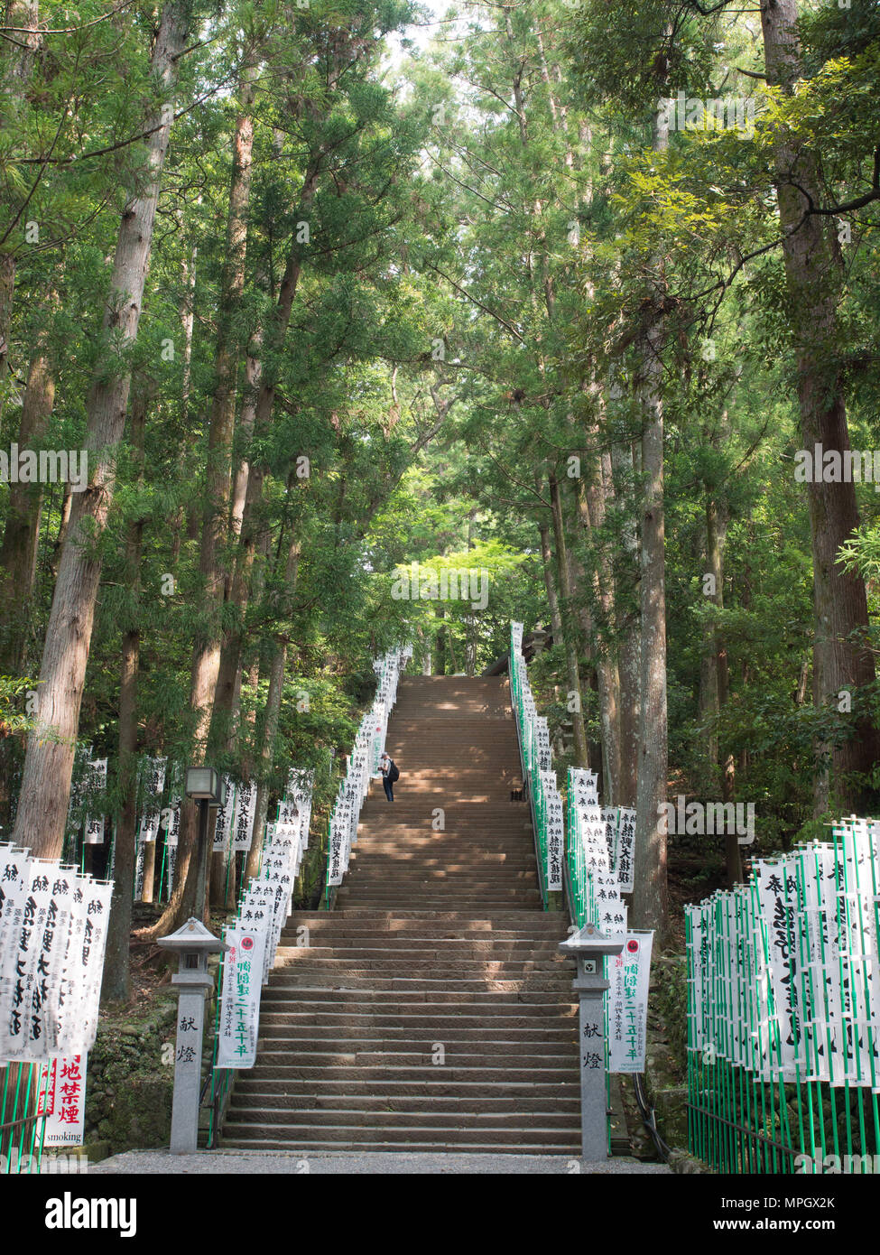 Visitors climb steep stone stairs leading to world heritage shrine ...