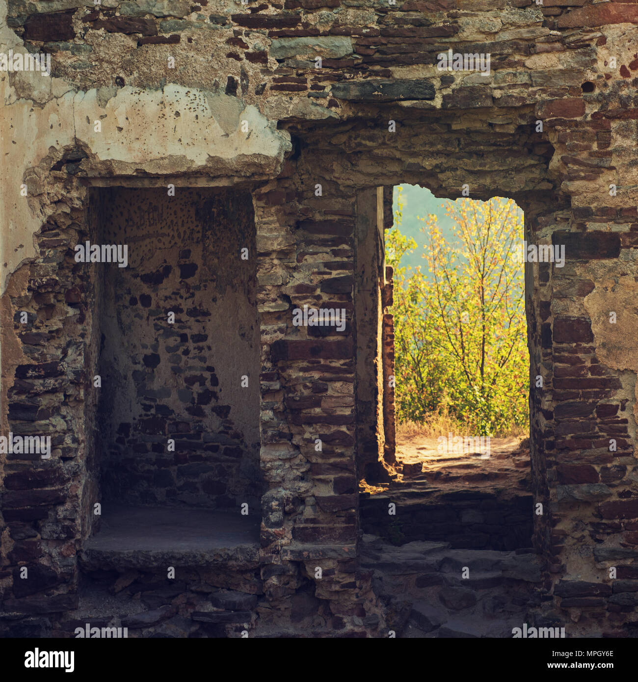 Old weathered ruined wall with breach from door, cracks and scratches ...