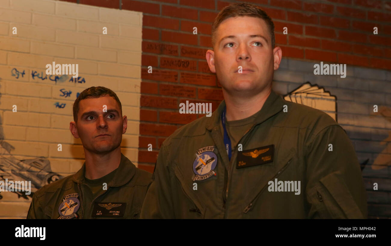 Capt. Taylor Zehrung , left, and Capt. Robert Reddy, right, watch as ...