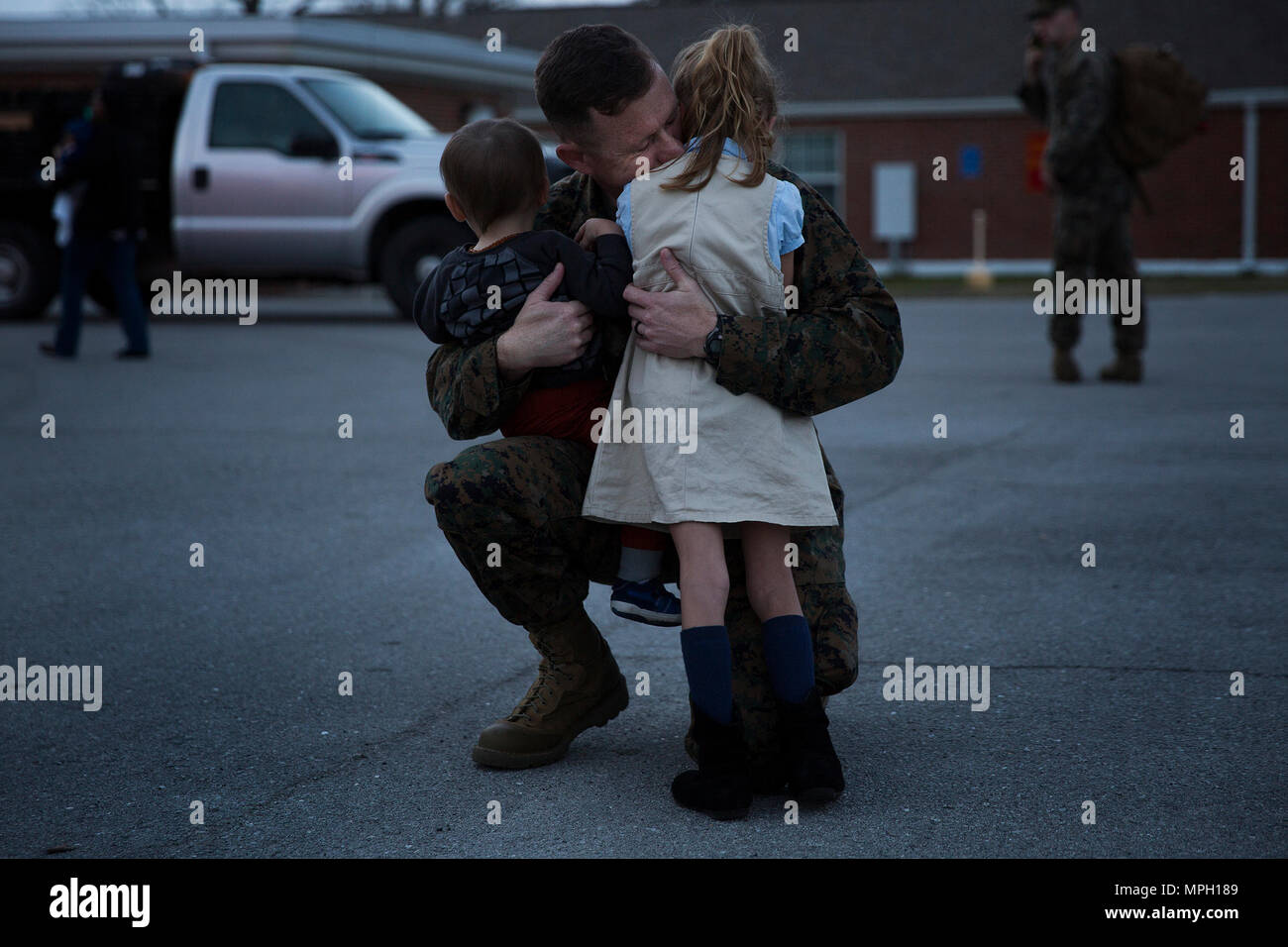 Capt. Christopher Skinner embraces his children Feb. 27, 2017, at a bus ...