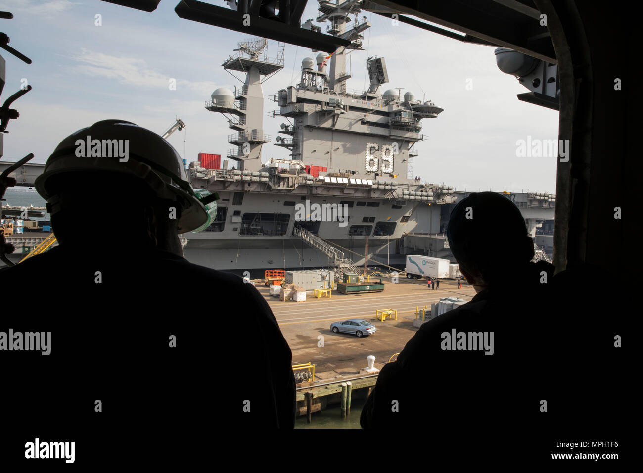 Sailors aboard the amphibious assault ship USS Bataan (LHD 5) observe ...