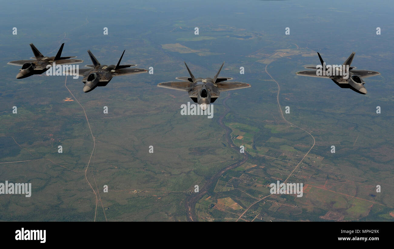 Four U.S. Air Force F-22 Raptors assigned to the 90th Fighter Squadron ...