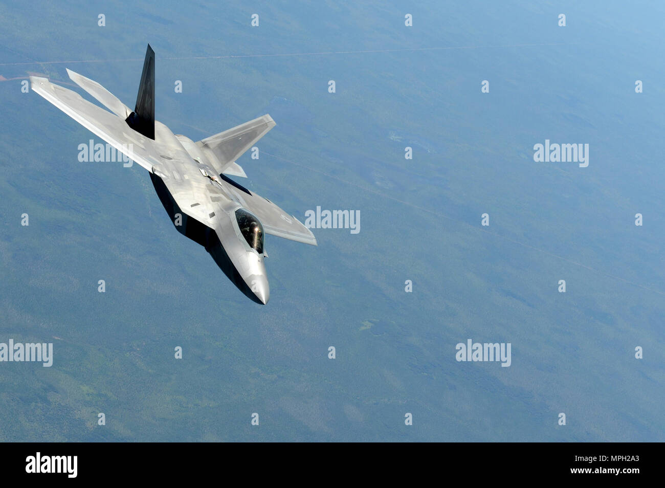 A U.S. Air Force F-22 Raptor flies above Royal Australian Air Force ...