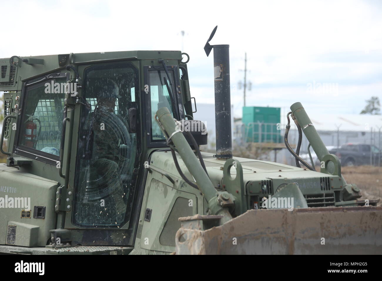 A Marine with Combat Logistics Battalion 22 operates a bulldozer during ...
