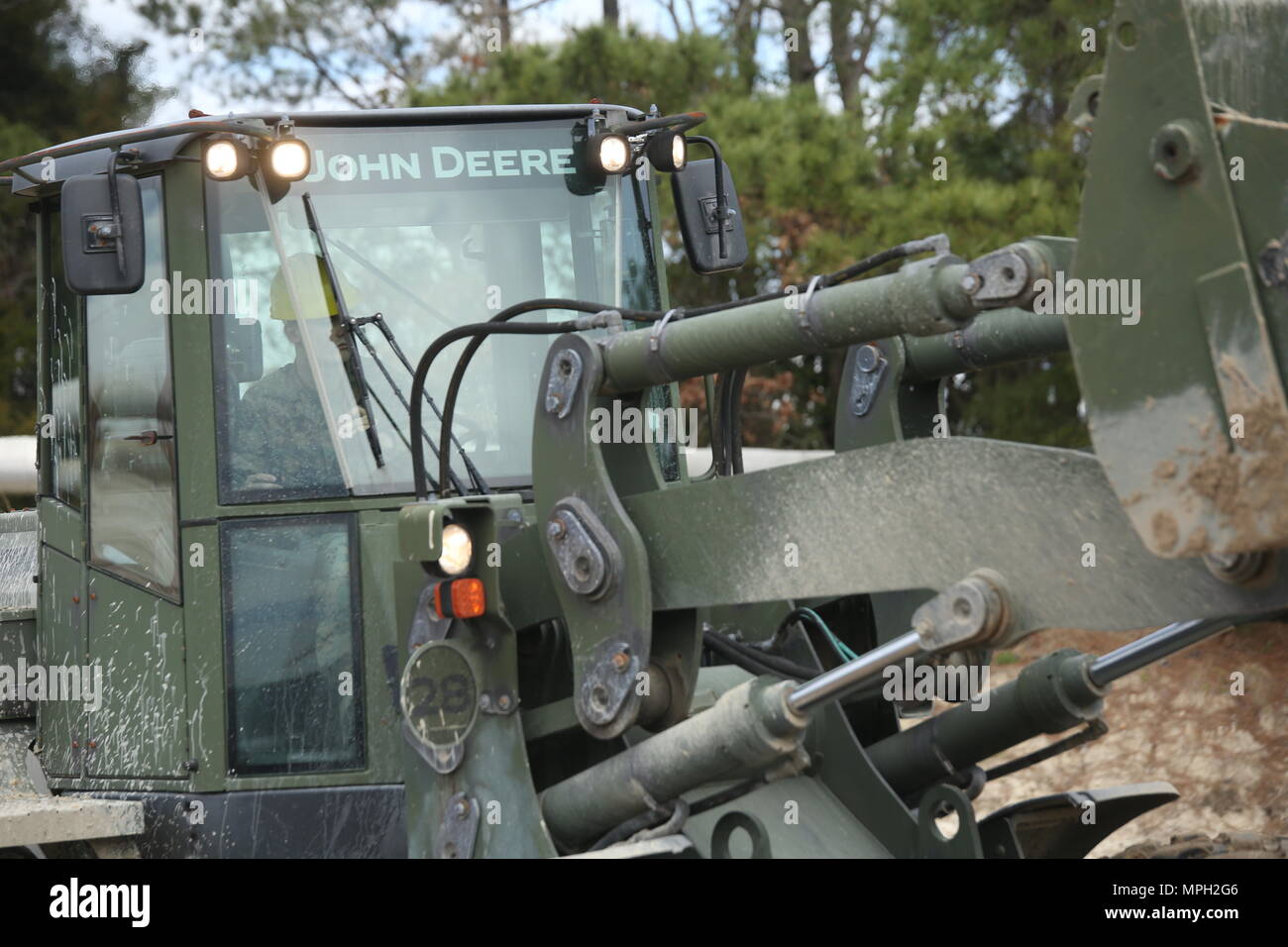 A Marine with Combat Logistics Battalion 22 operates a front-end loader ...