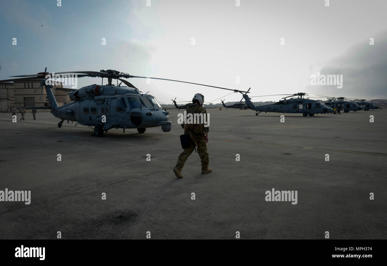 A U.S. Navy pilot from Helicopter Sea Combat Squadron 5 walks to an MH ...