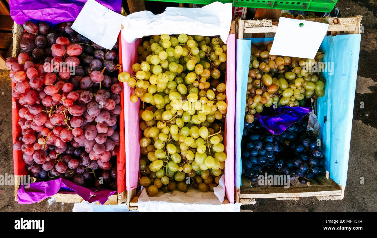 Grapes of different colors in wooden boxes in sunlight Stock Photo - Alamy