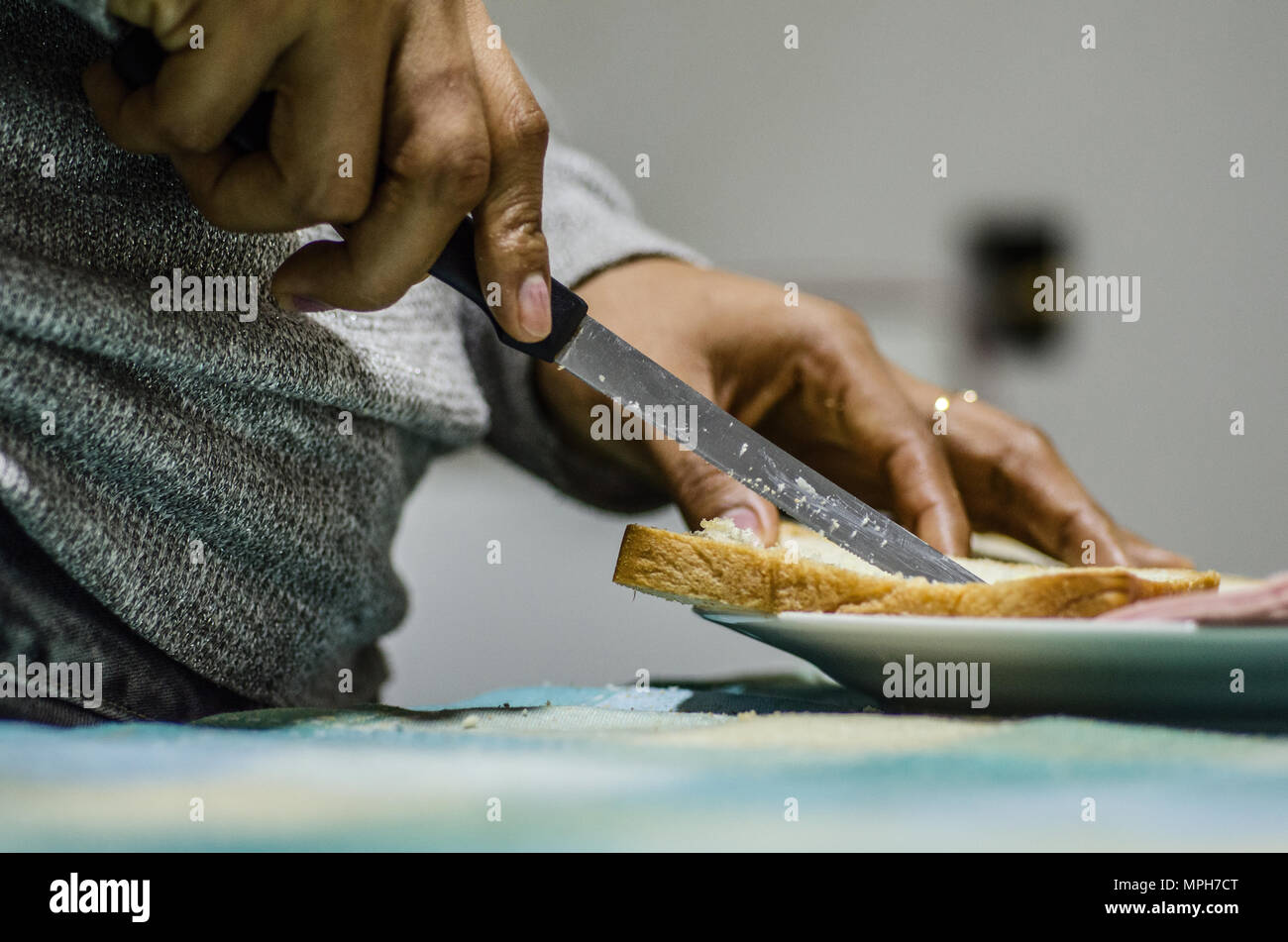 Female hands cut bread hi-res stock photography and images - Alamy