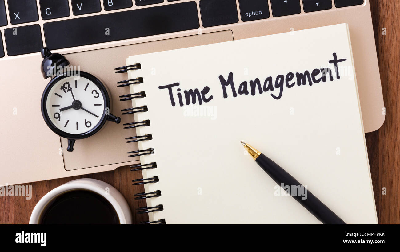 Time management concept with notebook, clock and pen on computer from ...