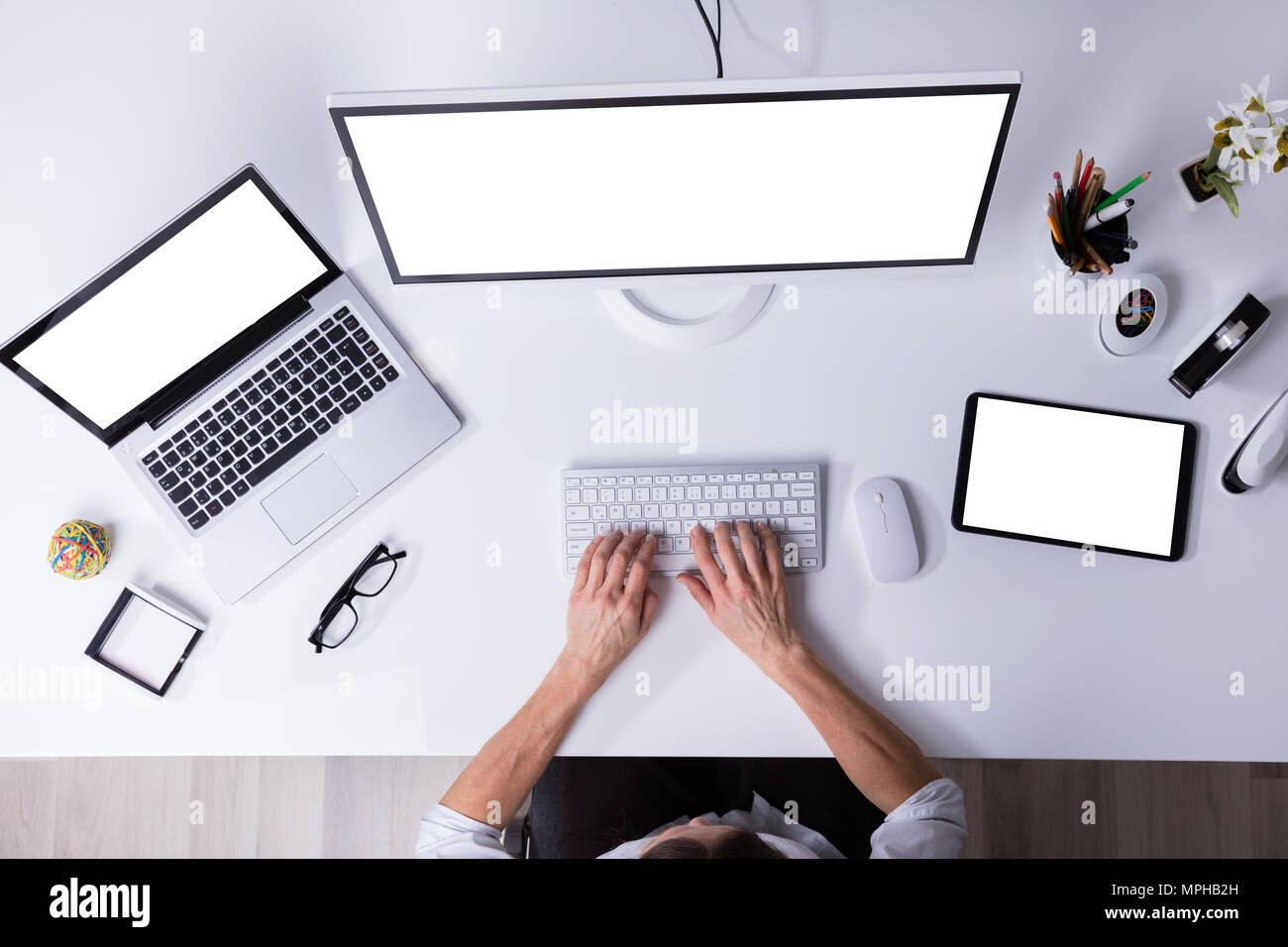 Businessperson Working On Computer With Blank White Screen Stock Photo ...