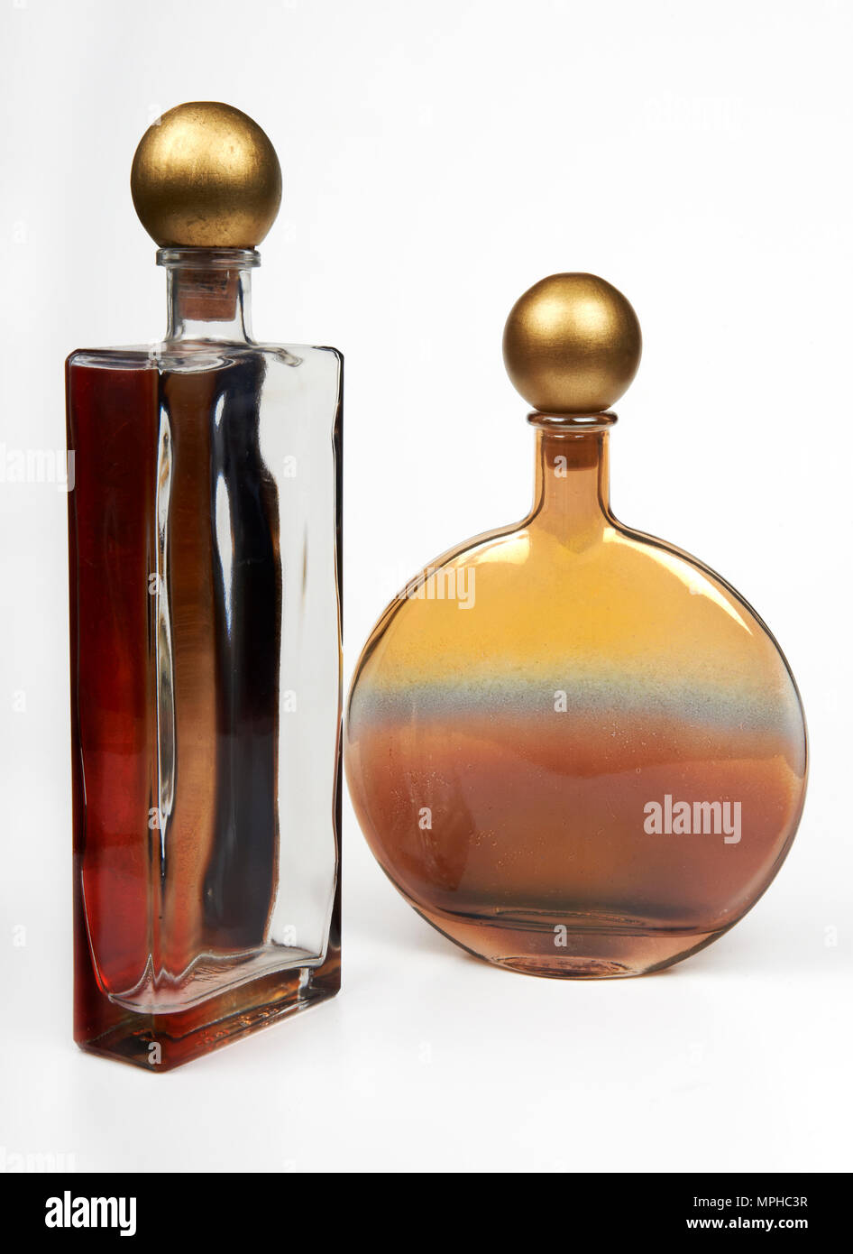 two colored bottles in white background Stock Photo - Alamy