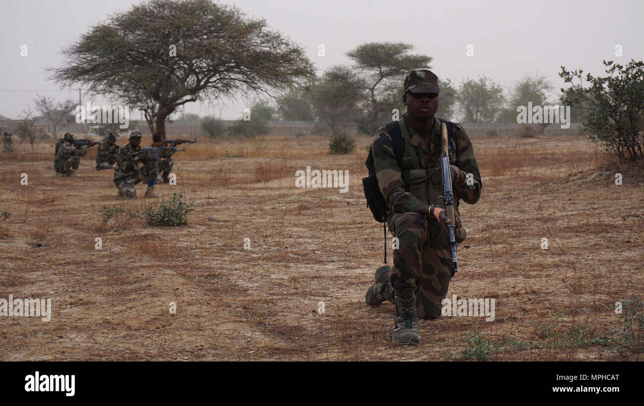 A Nigerien soldier provides rear security for his squad while they ...