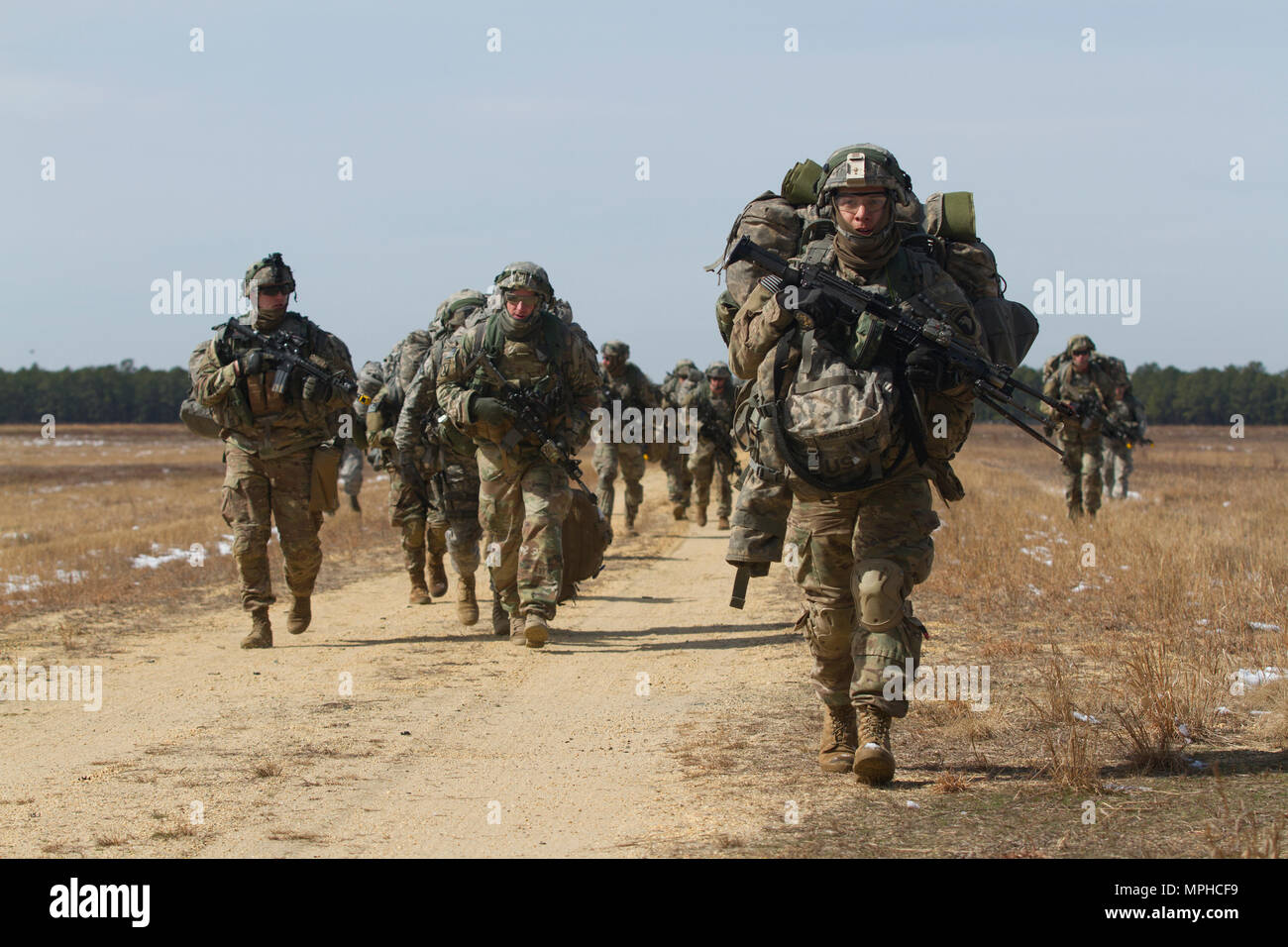 Soldiers assigned to 101st Airborne Division (Air Assault) move towards ...