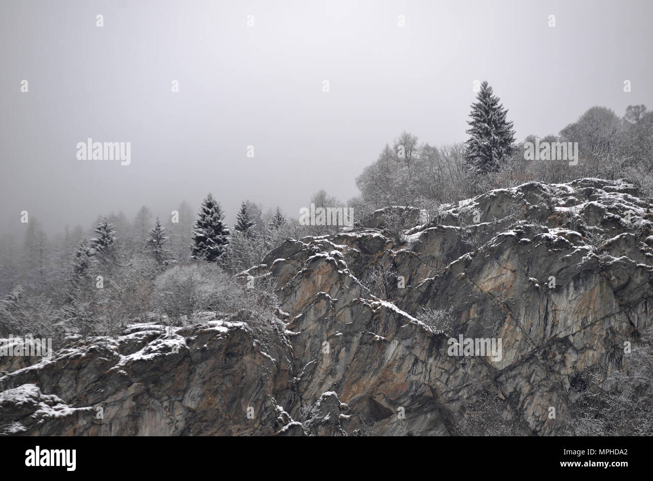 alpine winter landscape with fog and clouds Stock Photo - Alamy