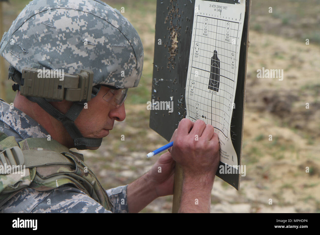 A Best Warrior Competitor checks his shot placement after zeroing M16 ...