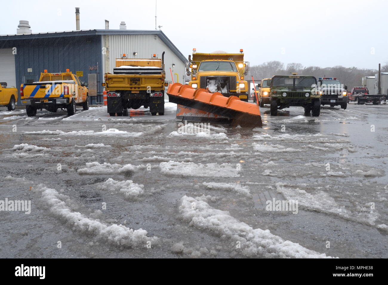 Military HUMVEE and Department of Transportation vehicles postured side ...