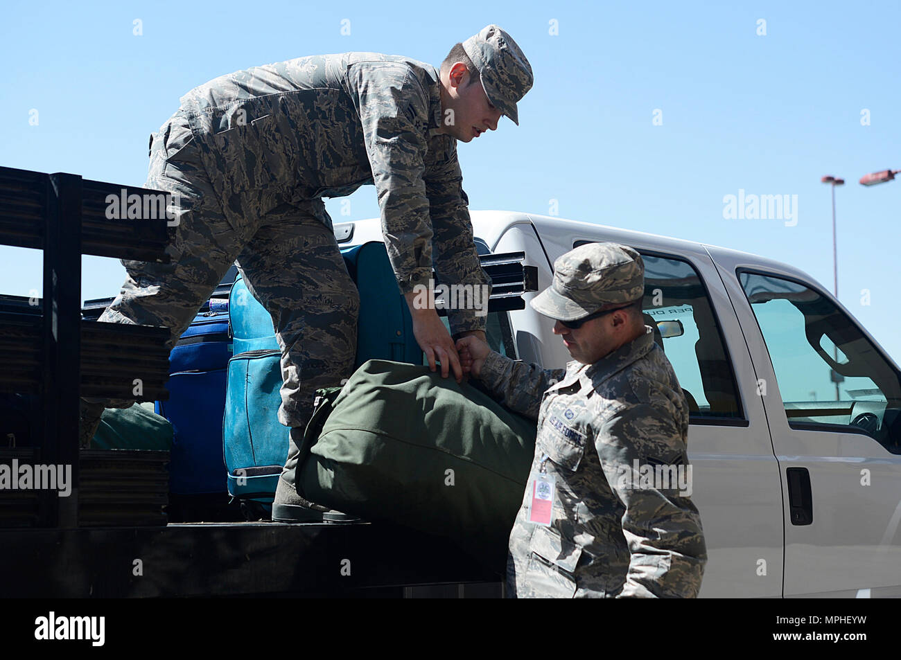Mayor Cell support members load luggage into a transport vehicle, March ...