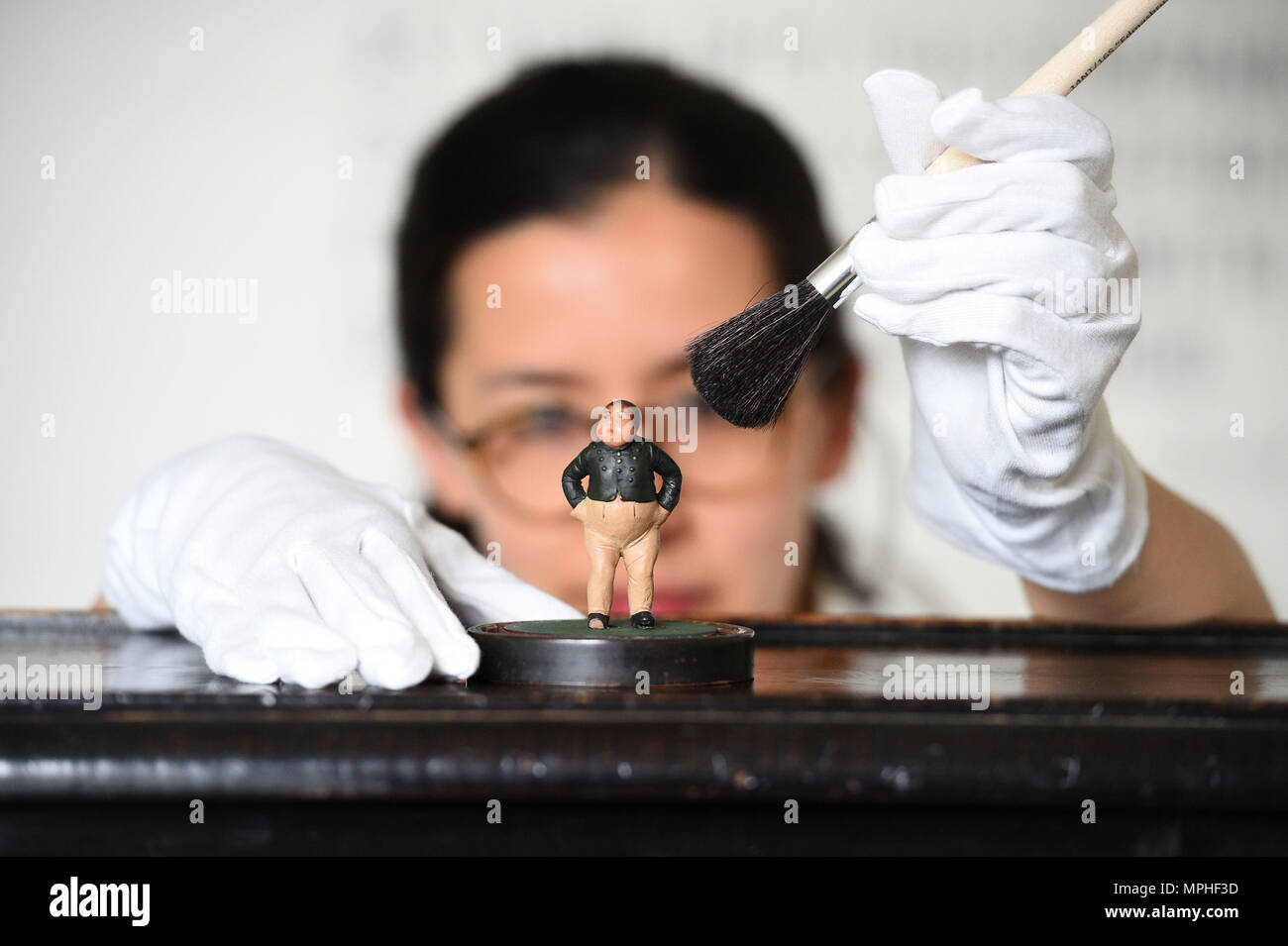 Museum assistant Louisa Price cleans a wax figurine of The Fat Boy from ...