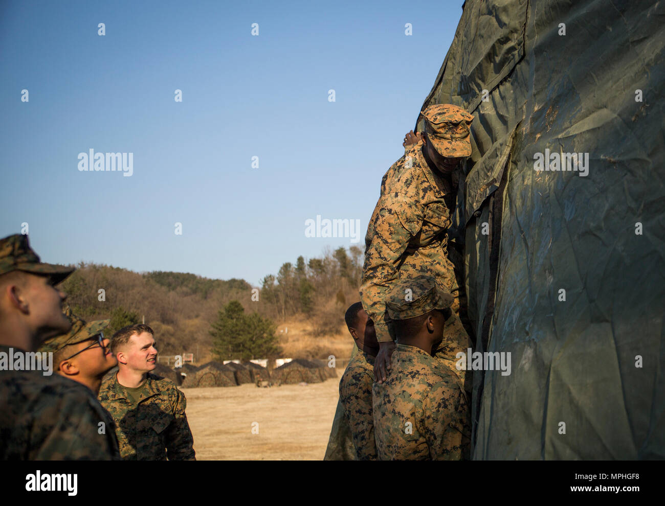 Cpl. Kenneth Wilson sets up a tent at an artillery school in Pohang ...