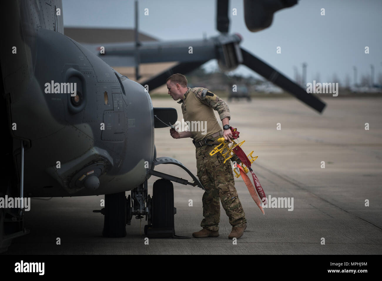 A flight engineer with the 8th Special Operations Squadron runs pre ...
