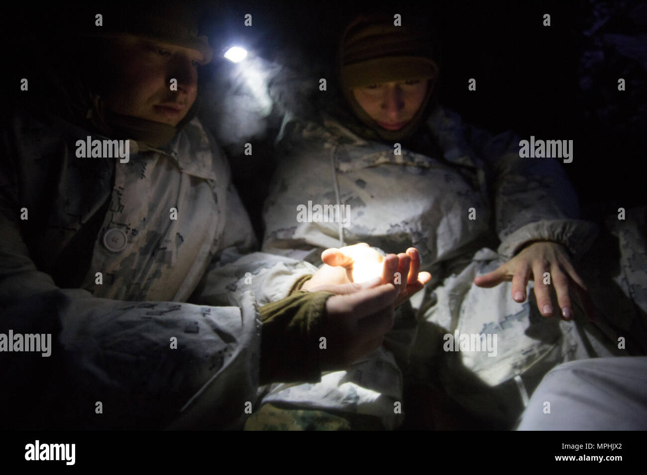 U.S. Marines Lance Cpl. Christopher Perez and Lance Cpl. Jacob Dement check fingers for cold ...