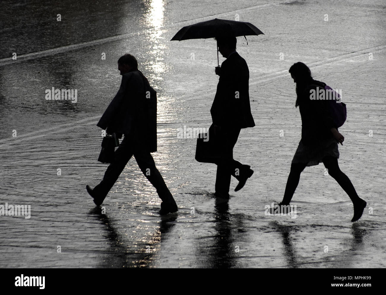 People silhouettes in the rain in Moscow Stock Photo - Alamy