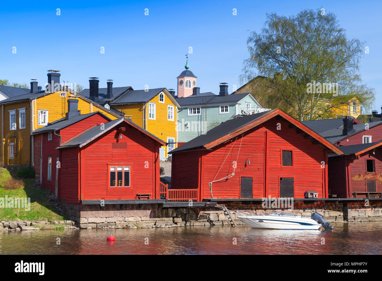 Porvoo town, Finland. Old red wooden houses on the river coast in sunny ...
