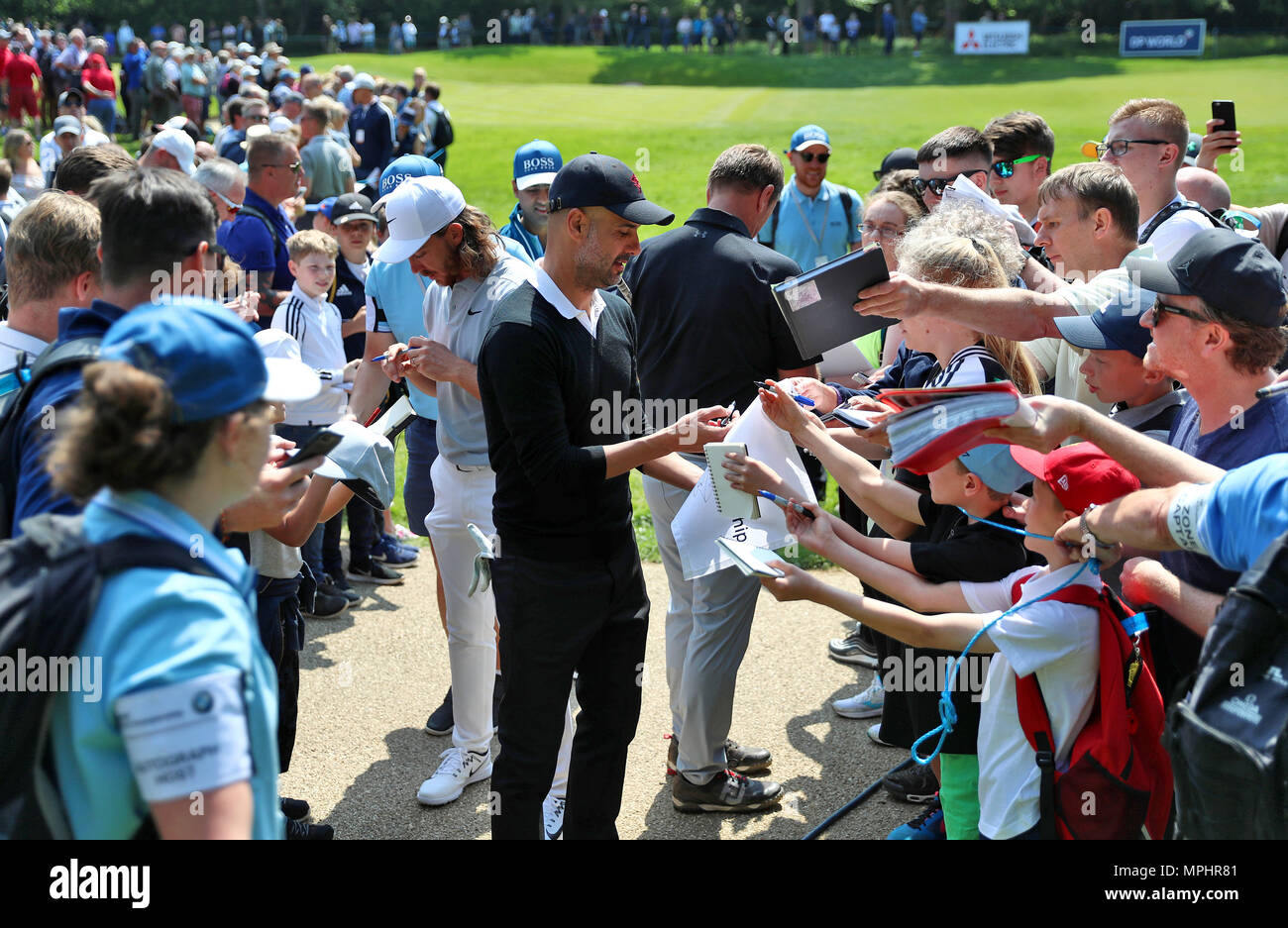 England's Tommy Fleetwood (left) and Pep Guardiola sign autographs ...