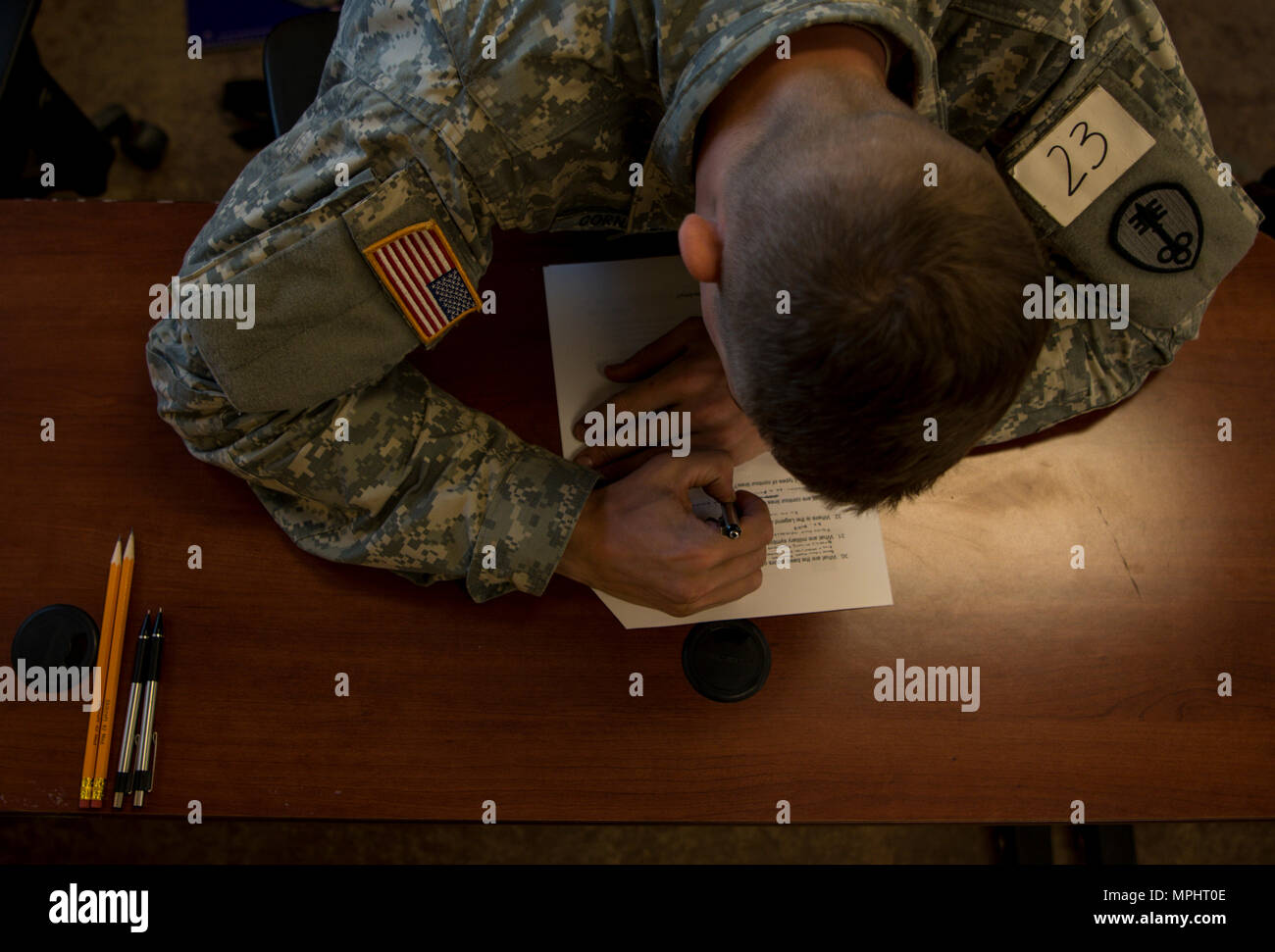 U.S. Army Spc. William Cornacchione takes a written exam during the ...
