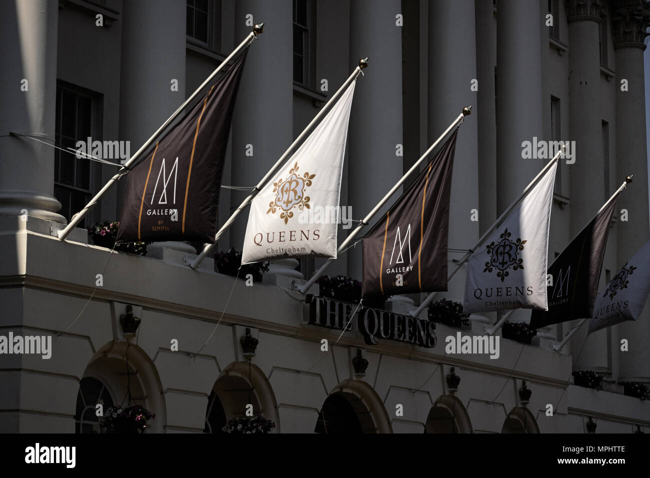 Sunlit flags on the above the main entrance to the Queens Hotel ...